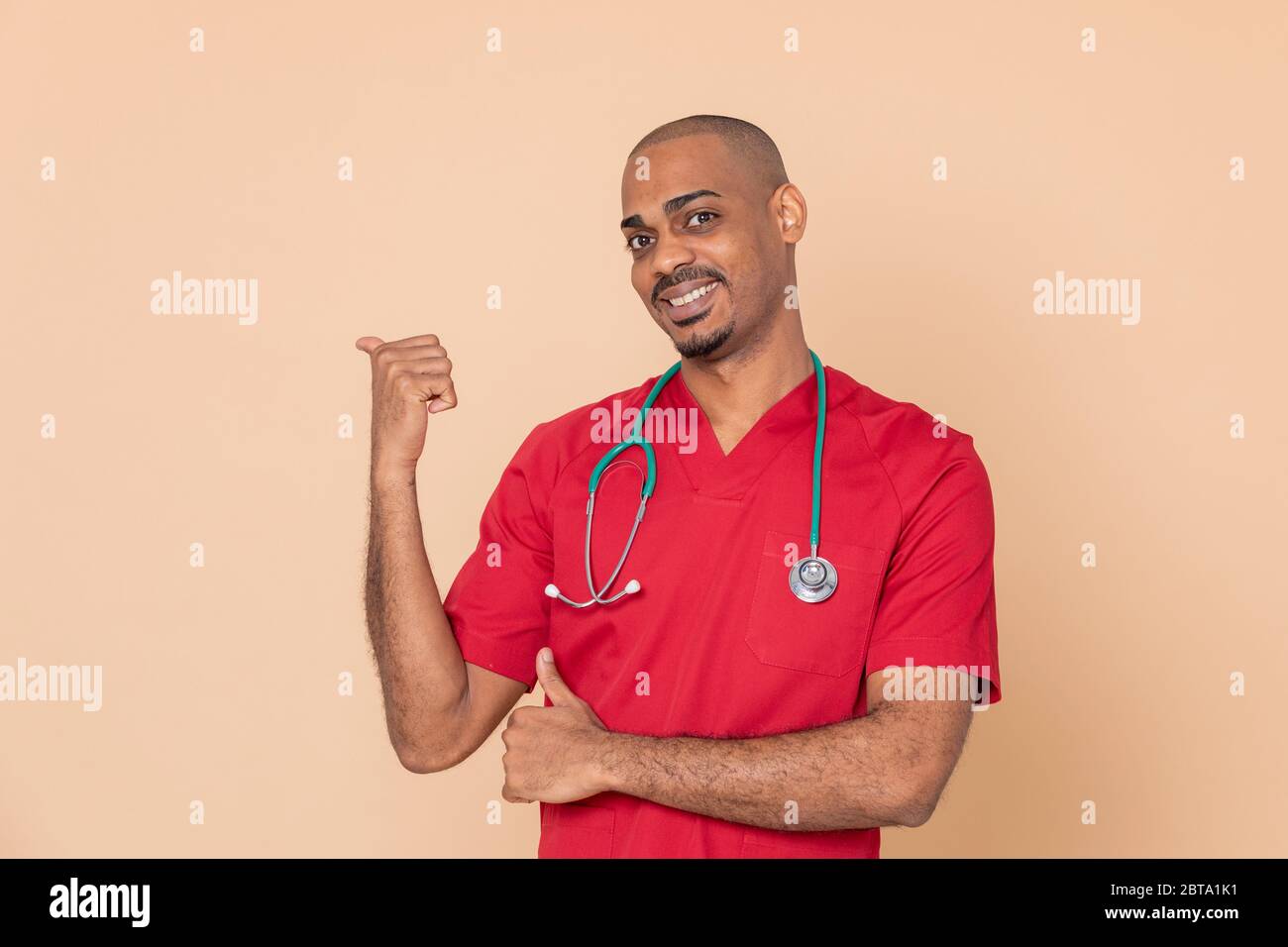 African doctor wearing red uniform on a orange background Stock Photo ...