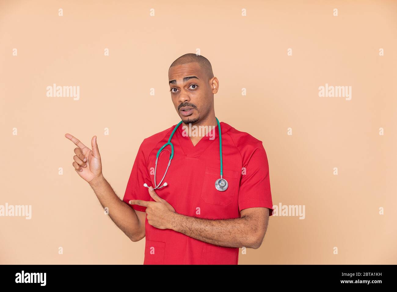African doctor wearing red uniform on a orange background Stock Photo ...