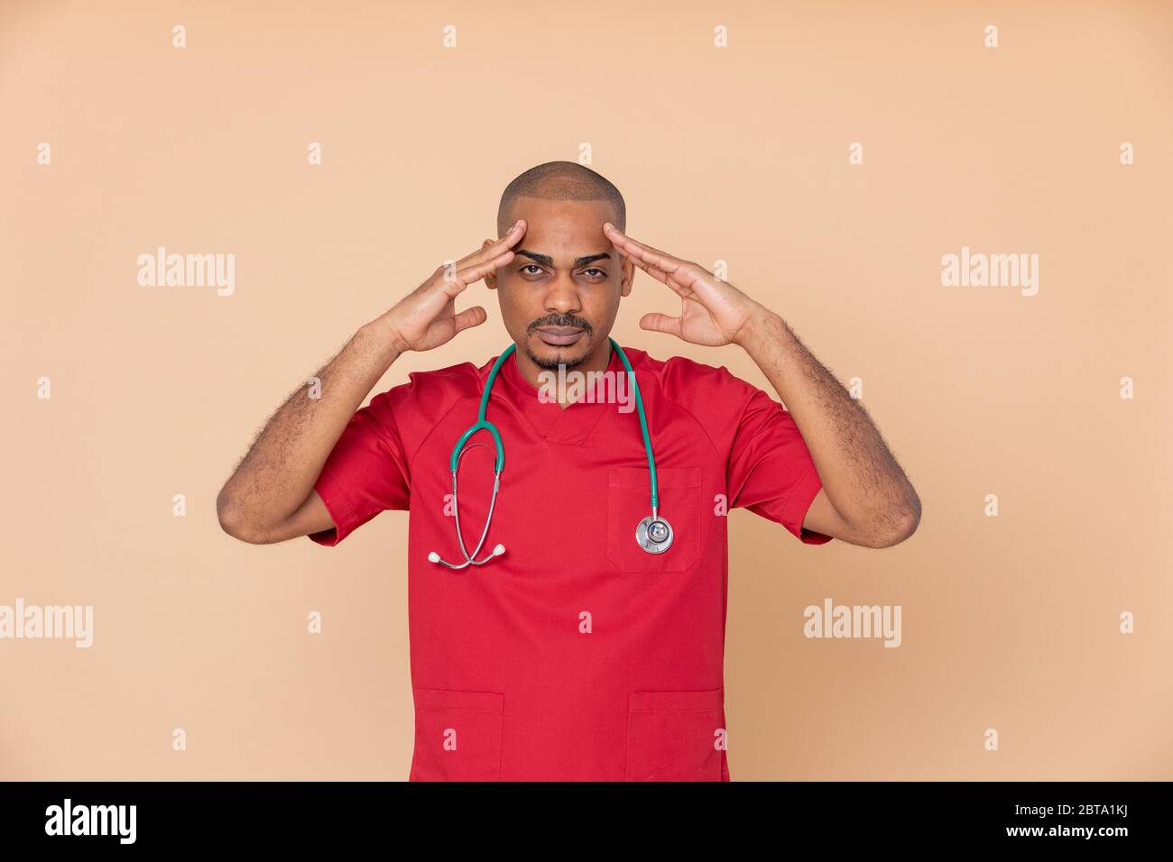 African doctor wearing red uniform on a orange background Stock Photo ...