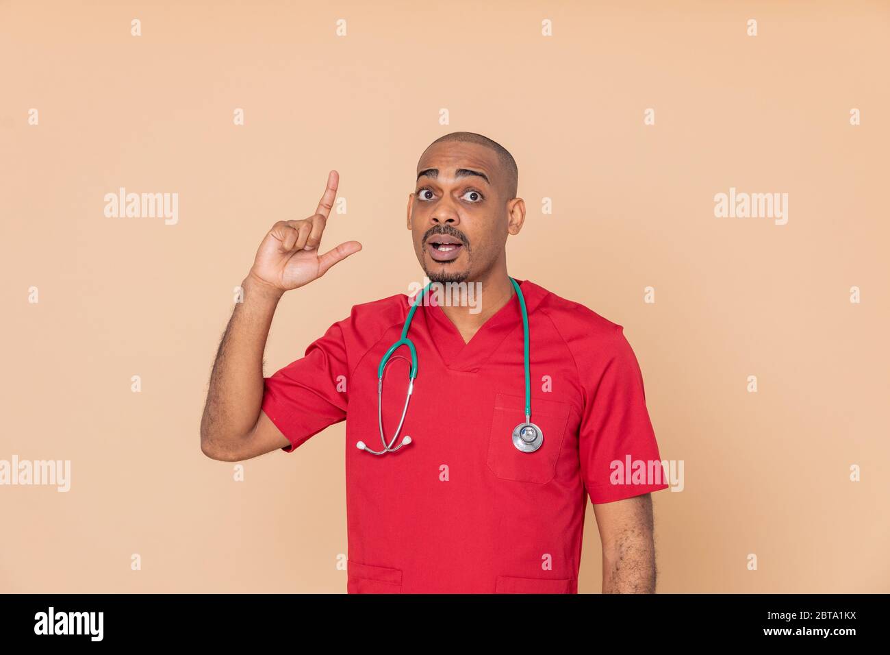 African doctor wearing red uniform on a orange background Stock Photo ...