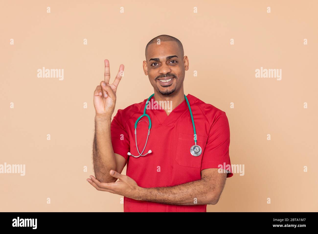 Winner African doctor wearing red uniform on a orange background Stock ...