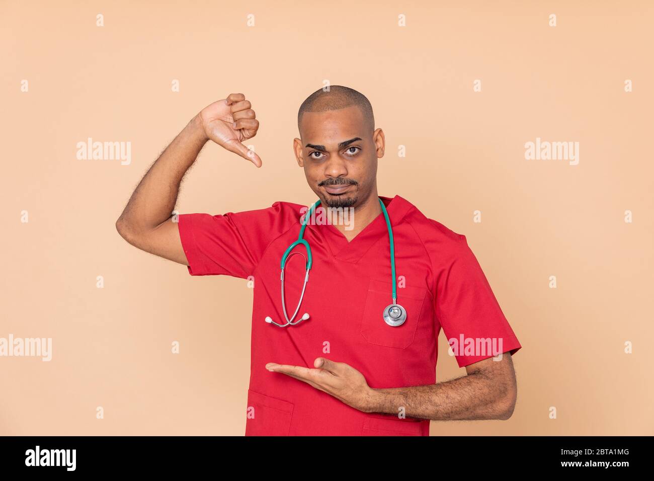 African doctor with a red uniform on a yellow background Stock Photo ...