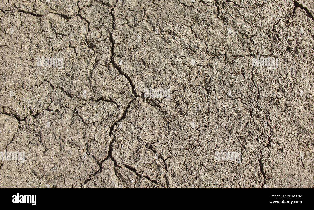 dry cracked ground soil background pattern design Stock Photo - Alamy