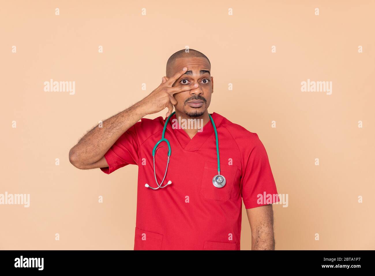 African doctor wearing red uniform on a orange background Stock Photo ...