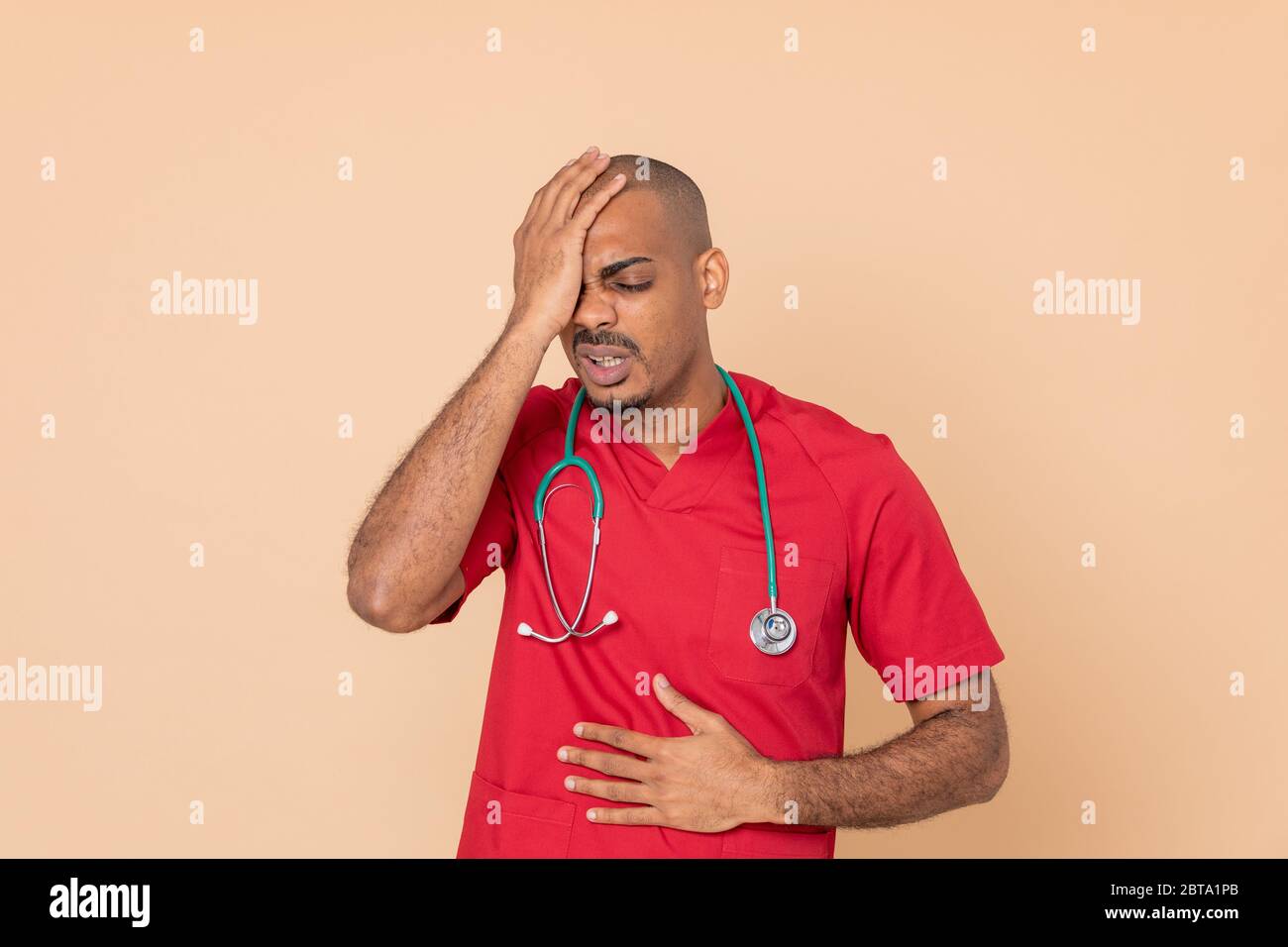 African doctor wearing red uniform on a orange background Stock Photo ...