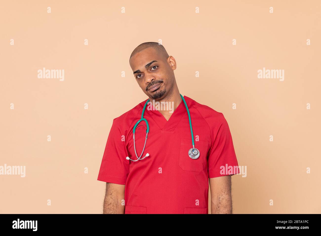 African doctor wearing a red uniform on a orange background Stock Photo ...