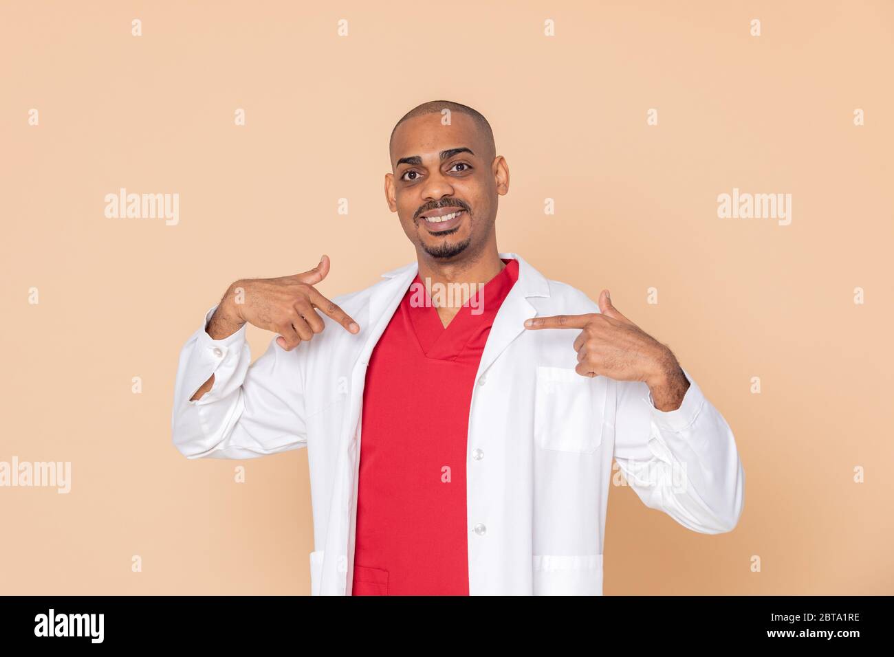 African doctor wearing red uniform on a orange background Stock Photo ...