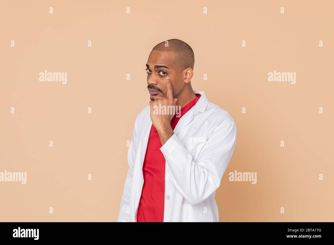 African doctor wearing red uniform on a orange background Stock Photo ...