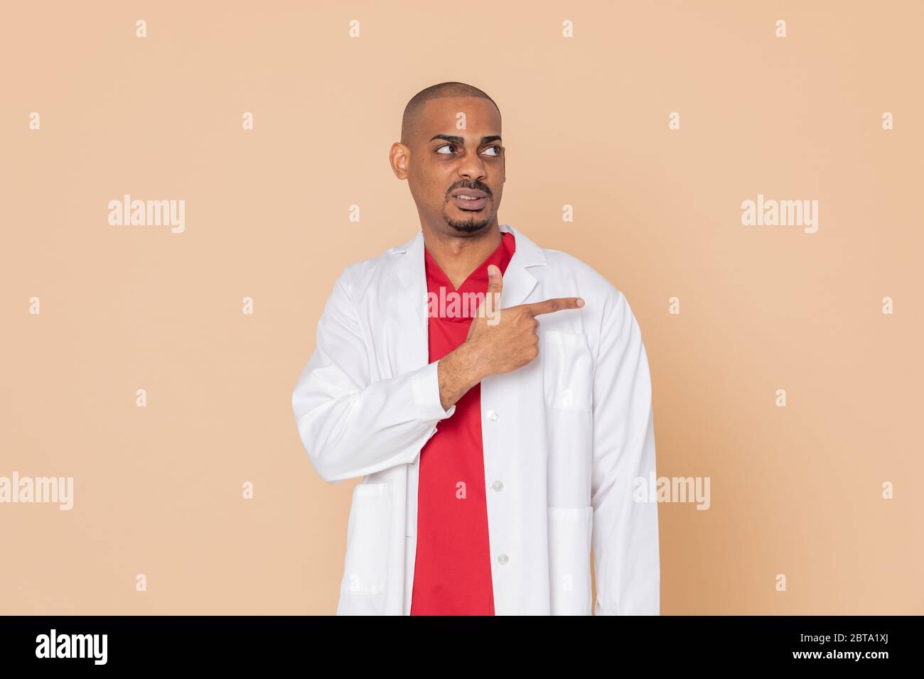 African doctor indicating something on a orange background Stock Photo ...