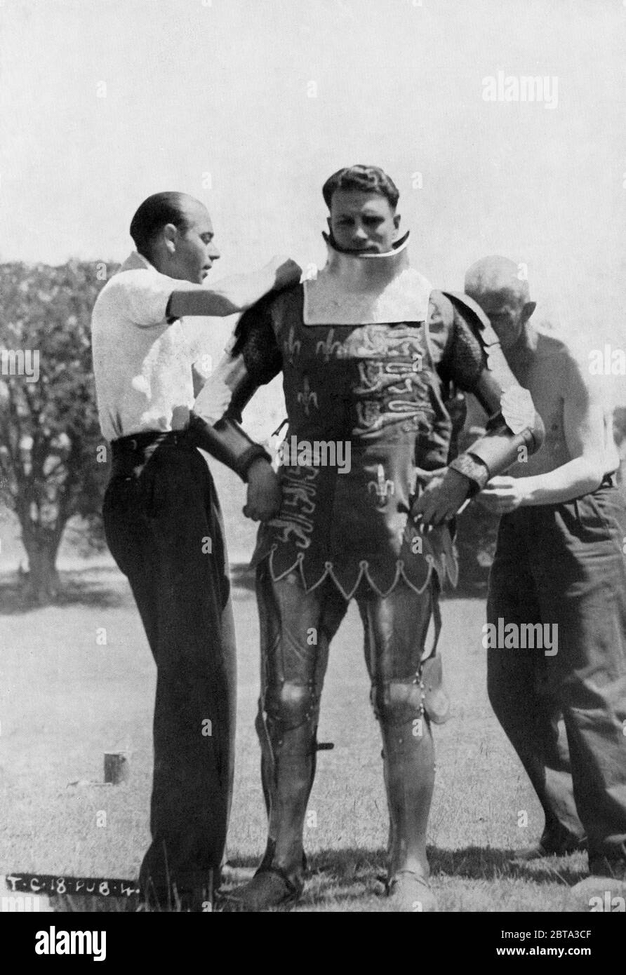 LAURENCE OLIVIER on set location candid being helped into his armour during filming in Ireland ...