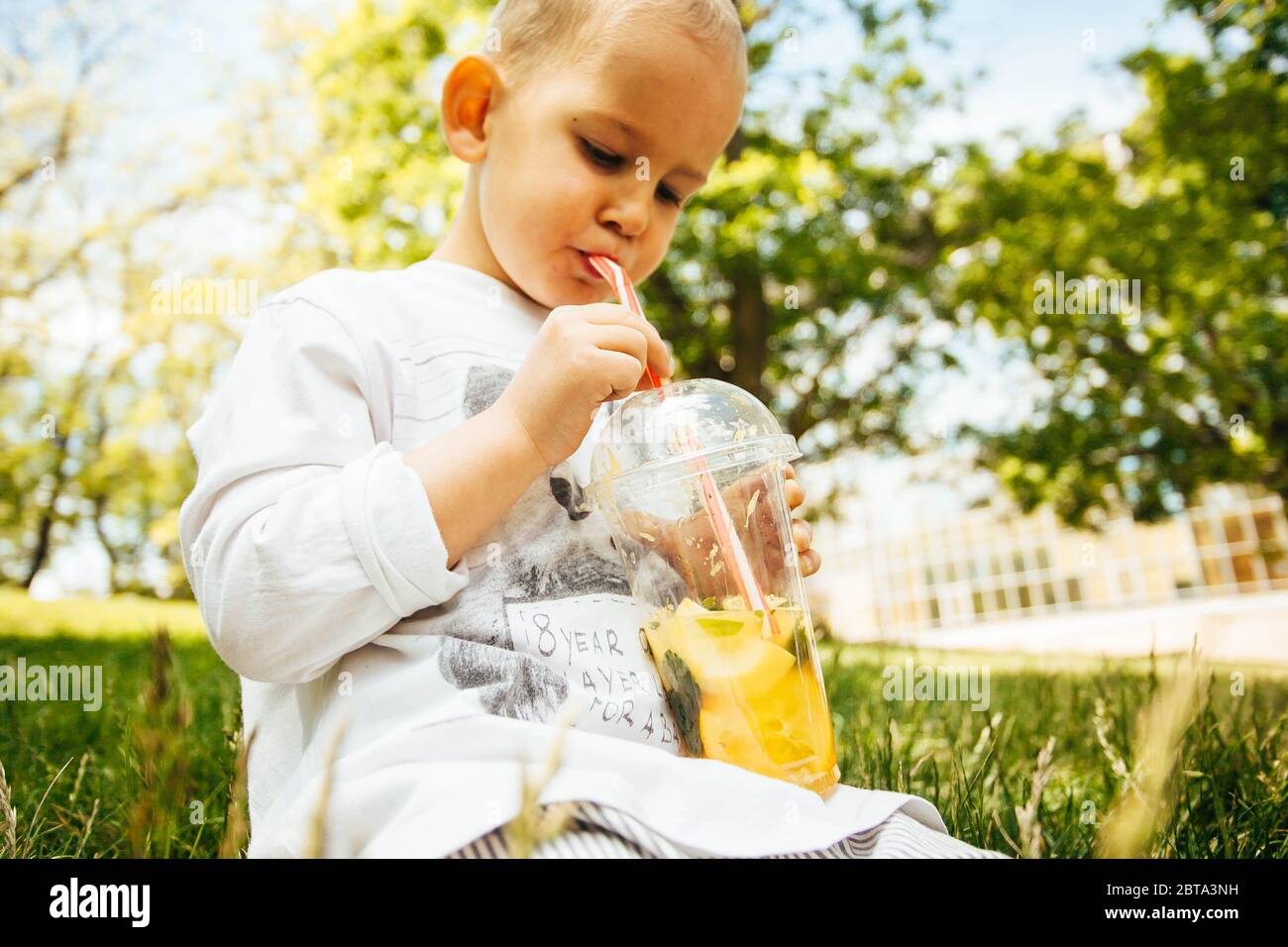 Little funny boy drinking a fresh lemonade through a straw Stock Photo - Alamy