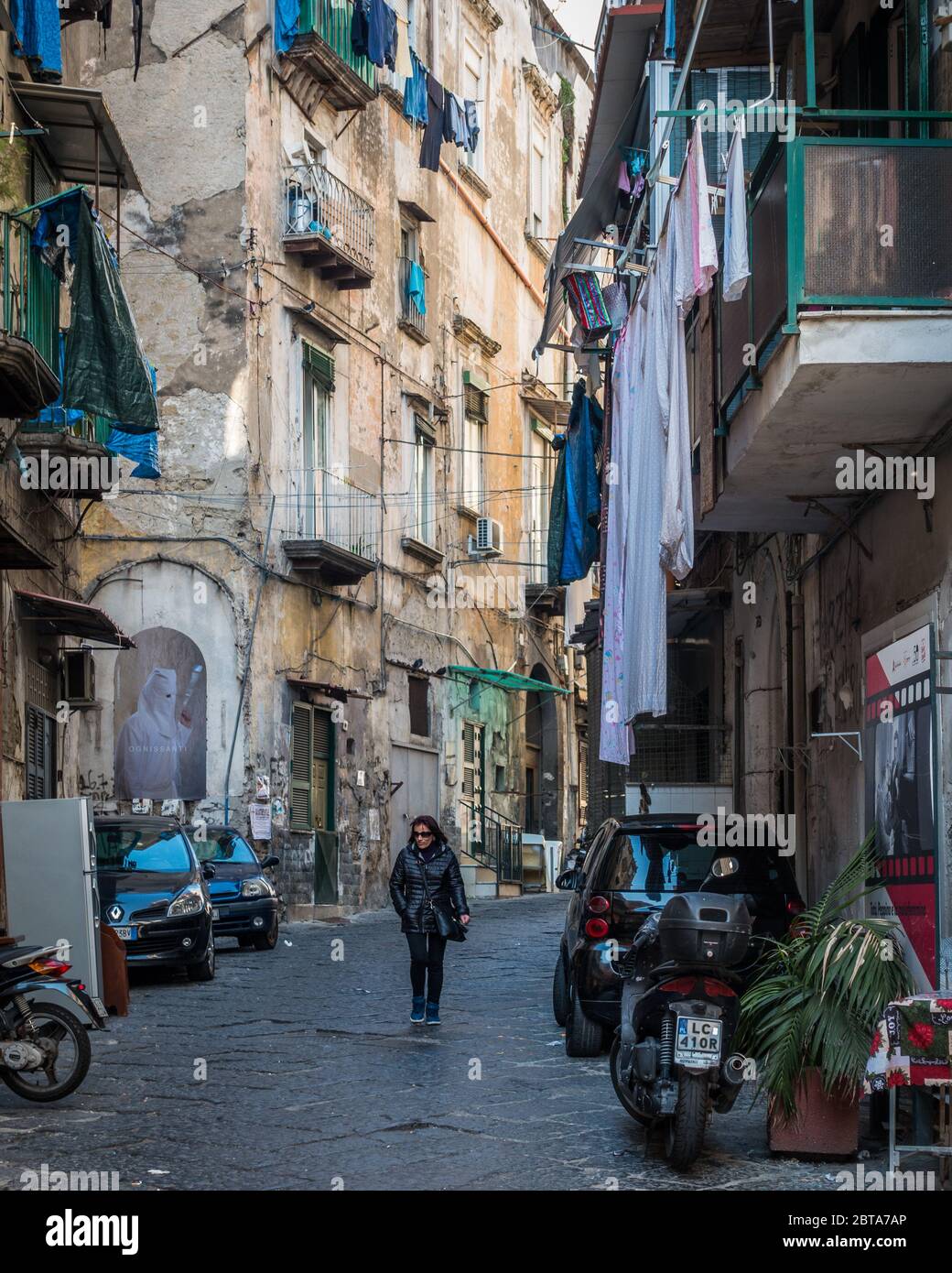 Naples, Italy, February 8, 2020 –A woman walking in a typical ...