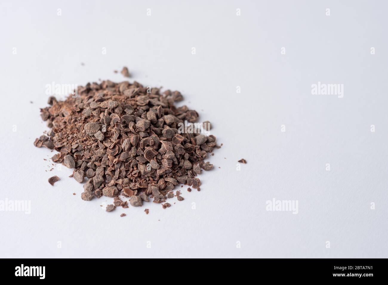 Chocolate granules used for making hot chocolate on a white background ...