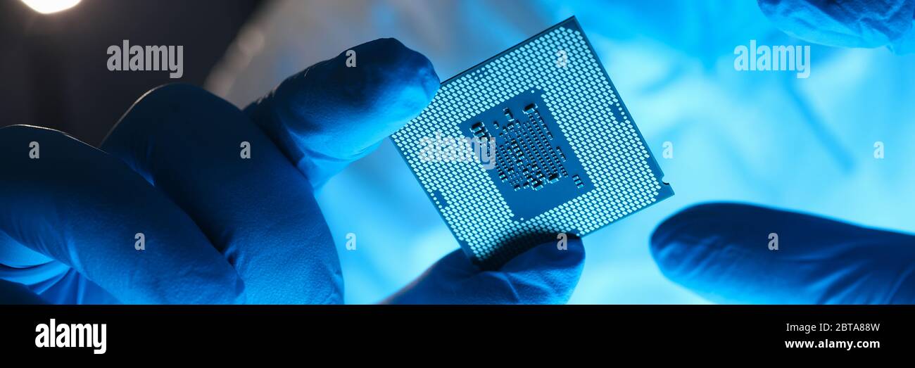Hands in gloves hold chip testing microelectronics Stock Photo - Alamy