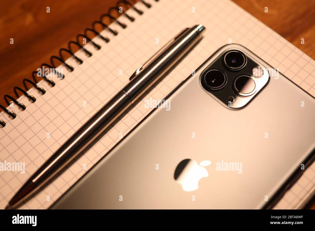 Apple iphone pro on notebook keyboard Stock Photo - Alamy