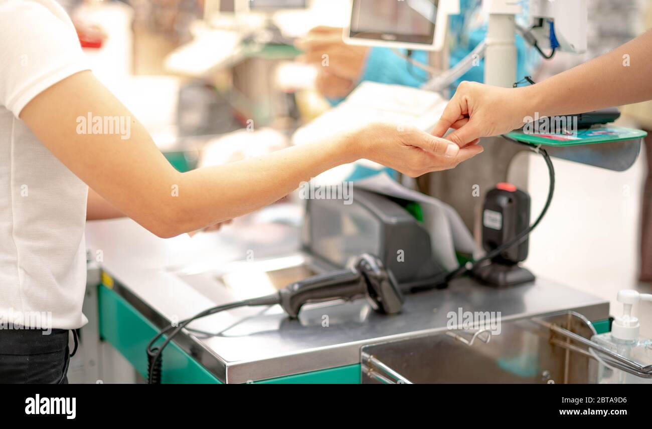 Female hand with coin money pay for goods concept. Hand giving cash and ...