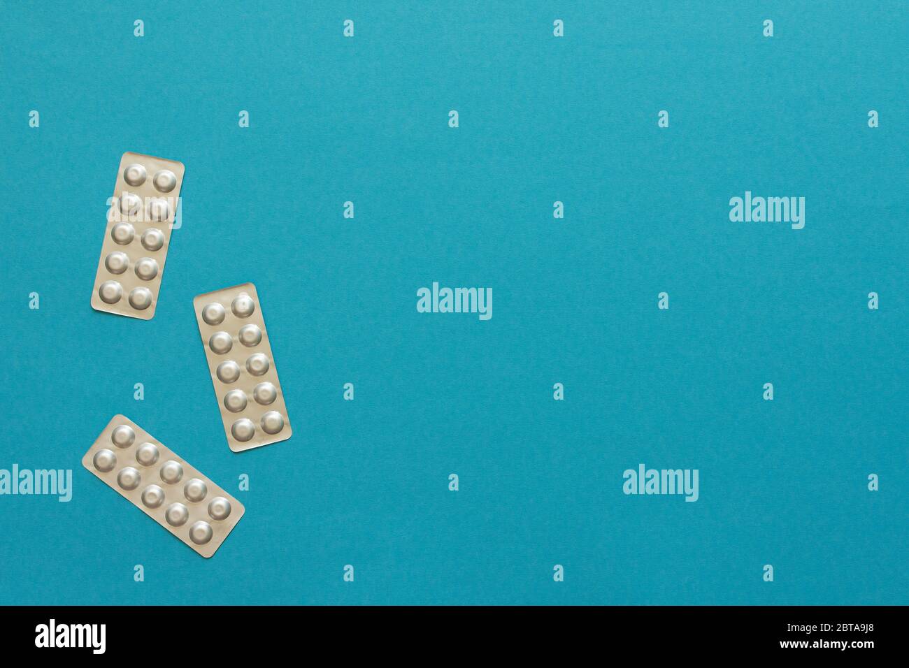 Blister packs with pills on a blue background, lowering blood ...