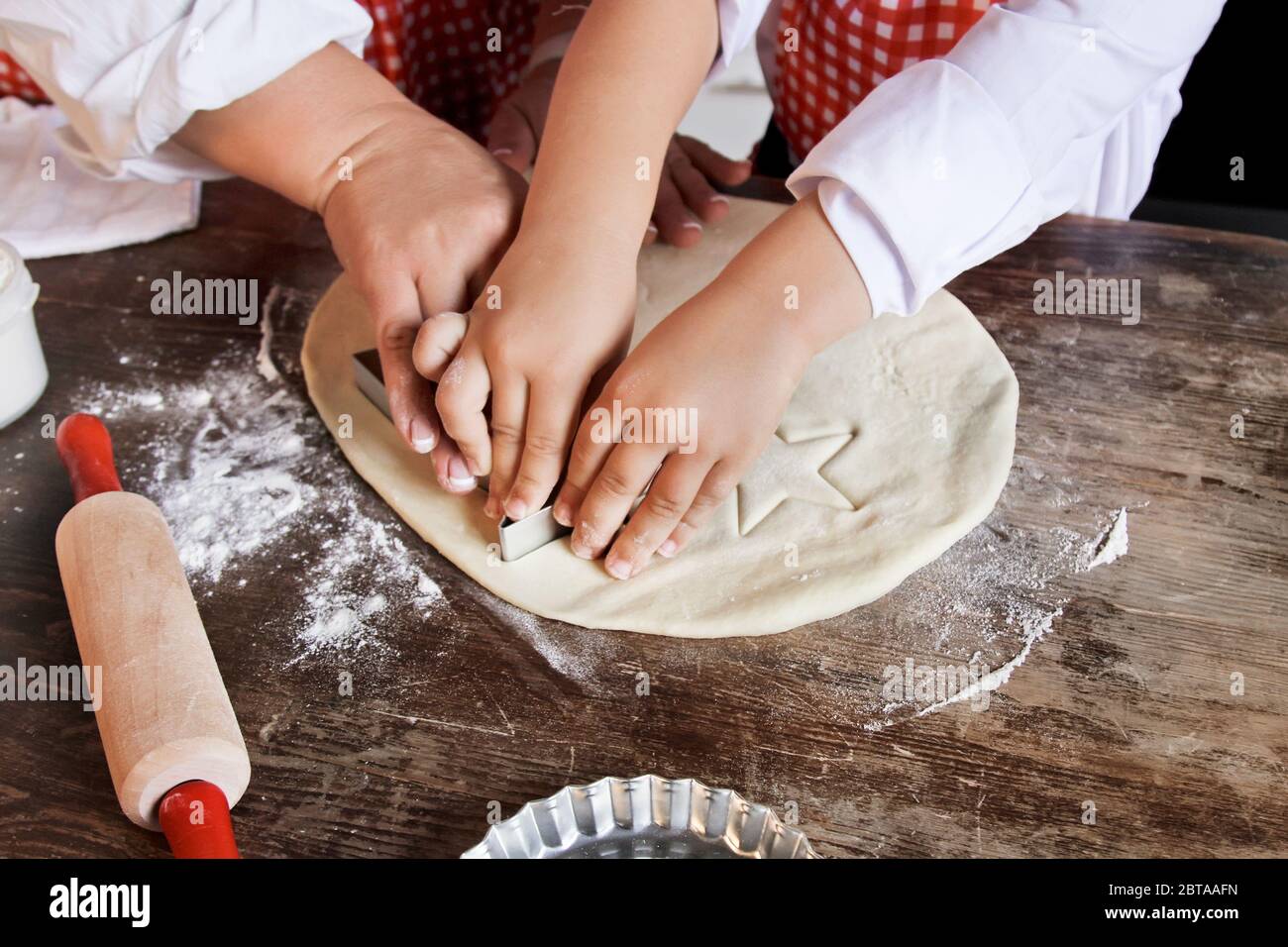 Happy family mother and little daughter make cookies and having fun in ...
