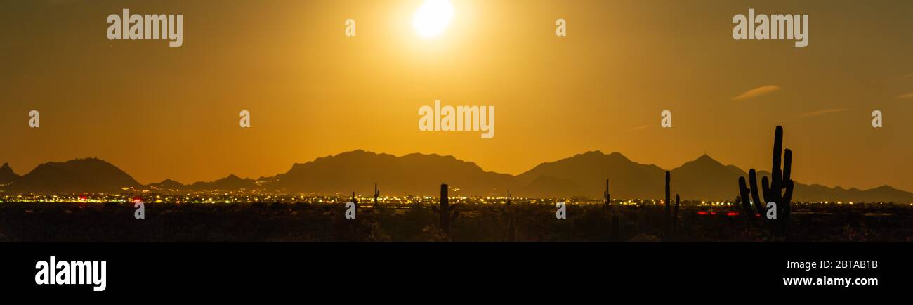 Long exposure panorama of the full moon rising on the desert and city ...