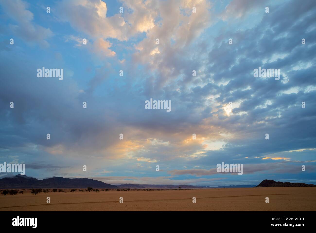Clouds at sunrise over the desert Stock Photo - Alamy