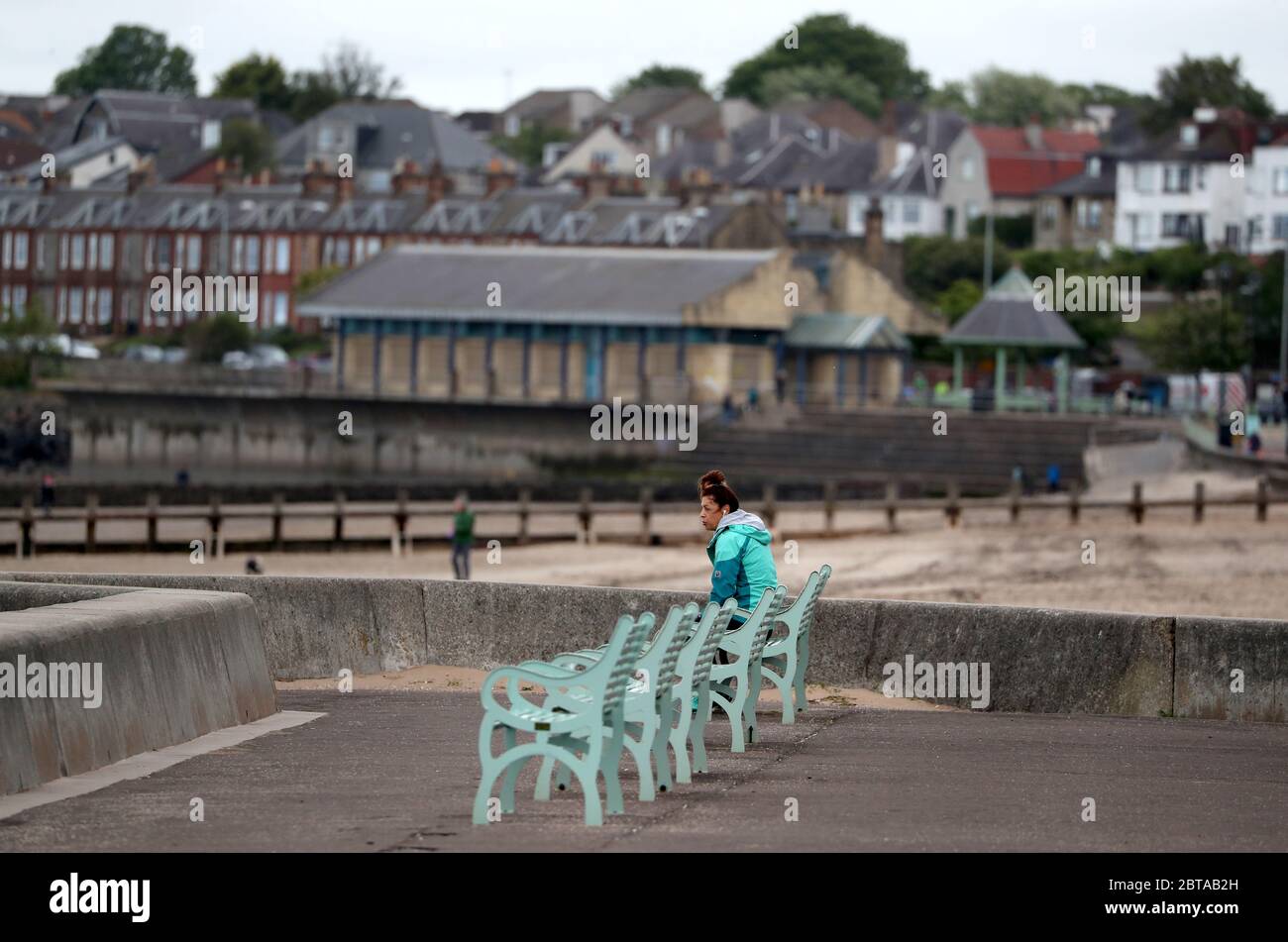 Sits on bench at portobello beach near edinburgh hi-res stock ...