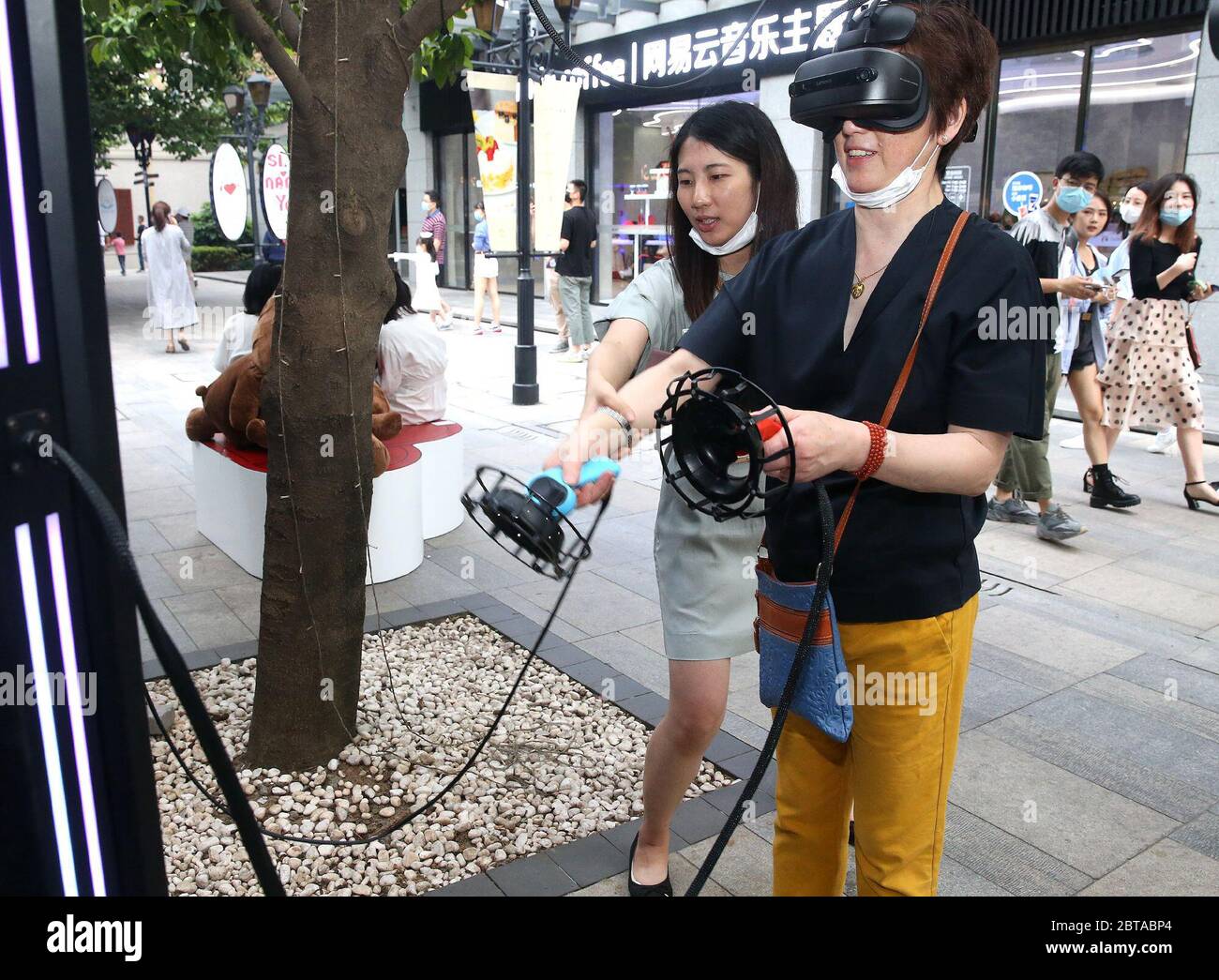 Shanghai, China. 24th May, 2020. A tourists experiences VR games at a ...