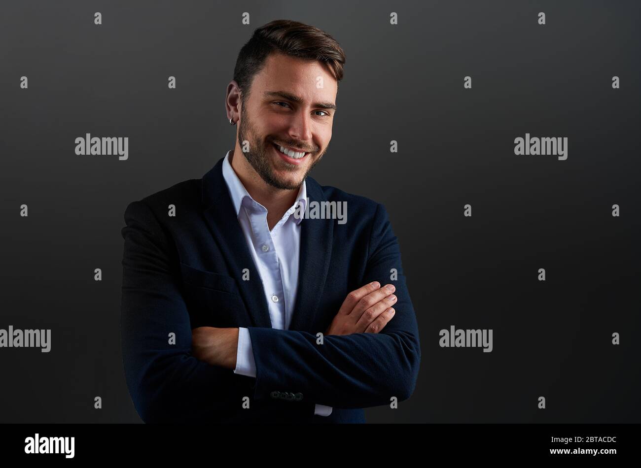 Portrait young smiling businessman. Caucasian guy business suit studio ...