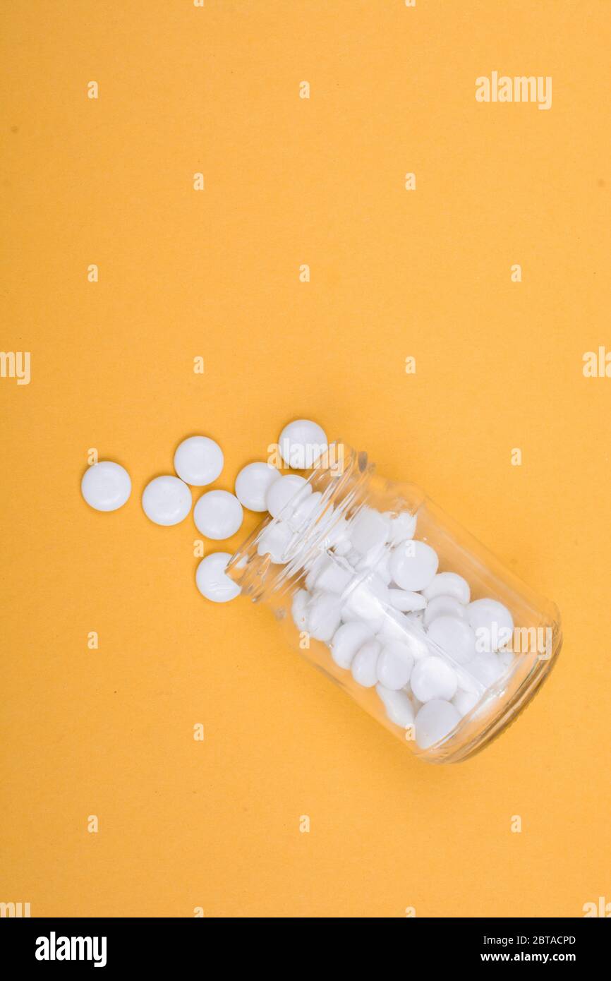 White pill and glass bottle container. Pharmaceutical industry ...