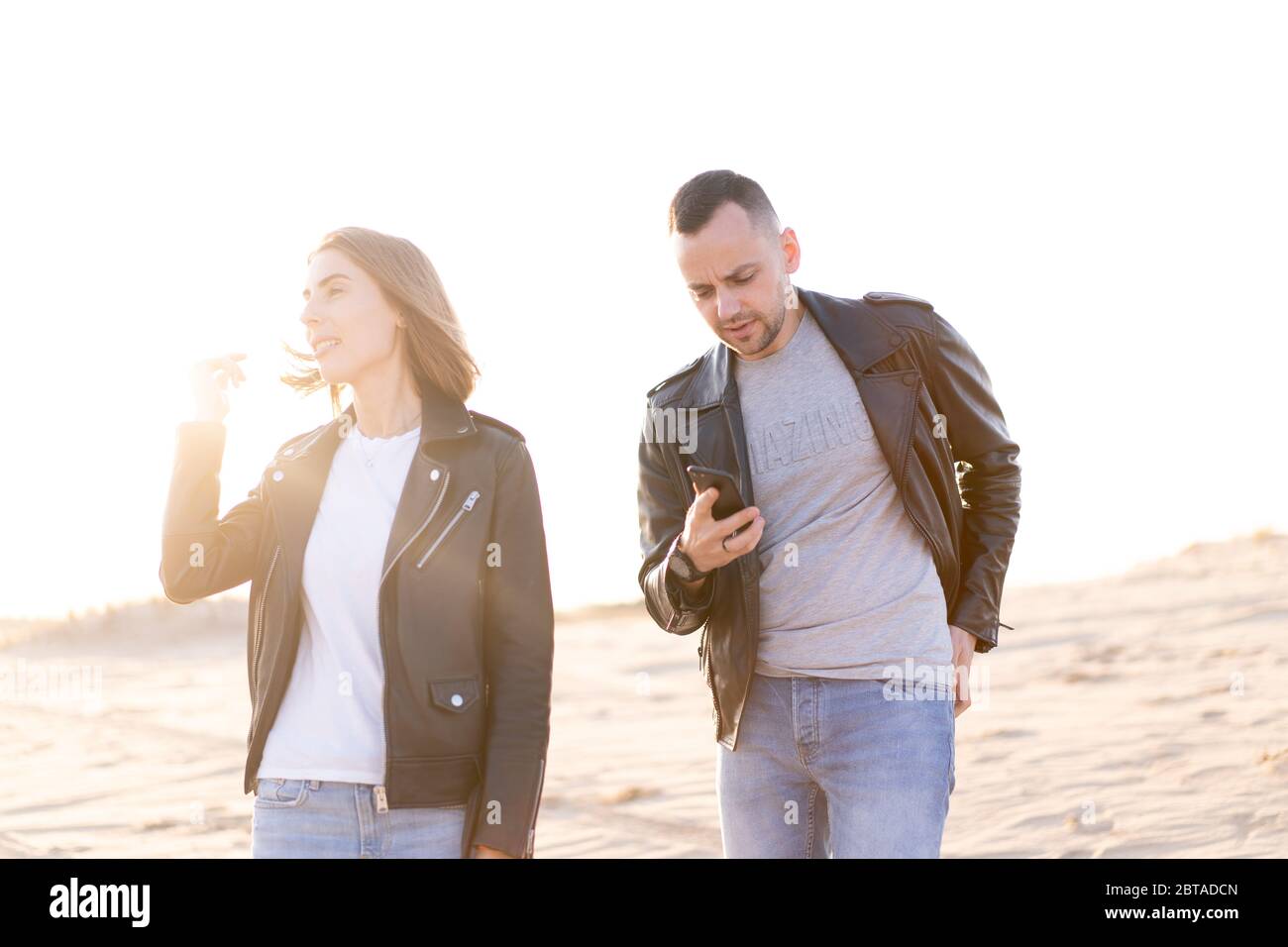 Happy and cute adorable adult couple leather jacket and jeans man with ...