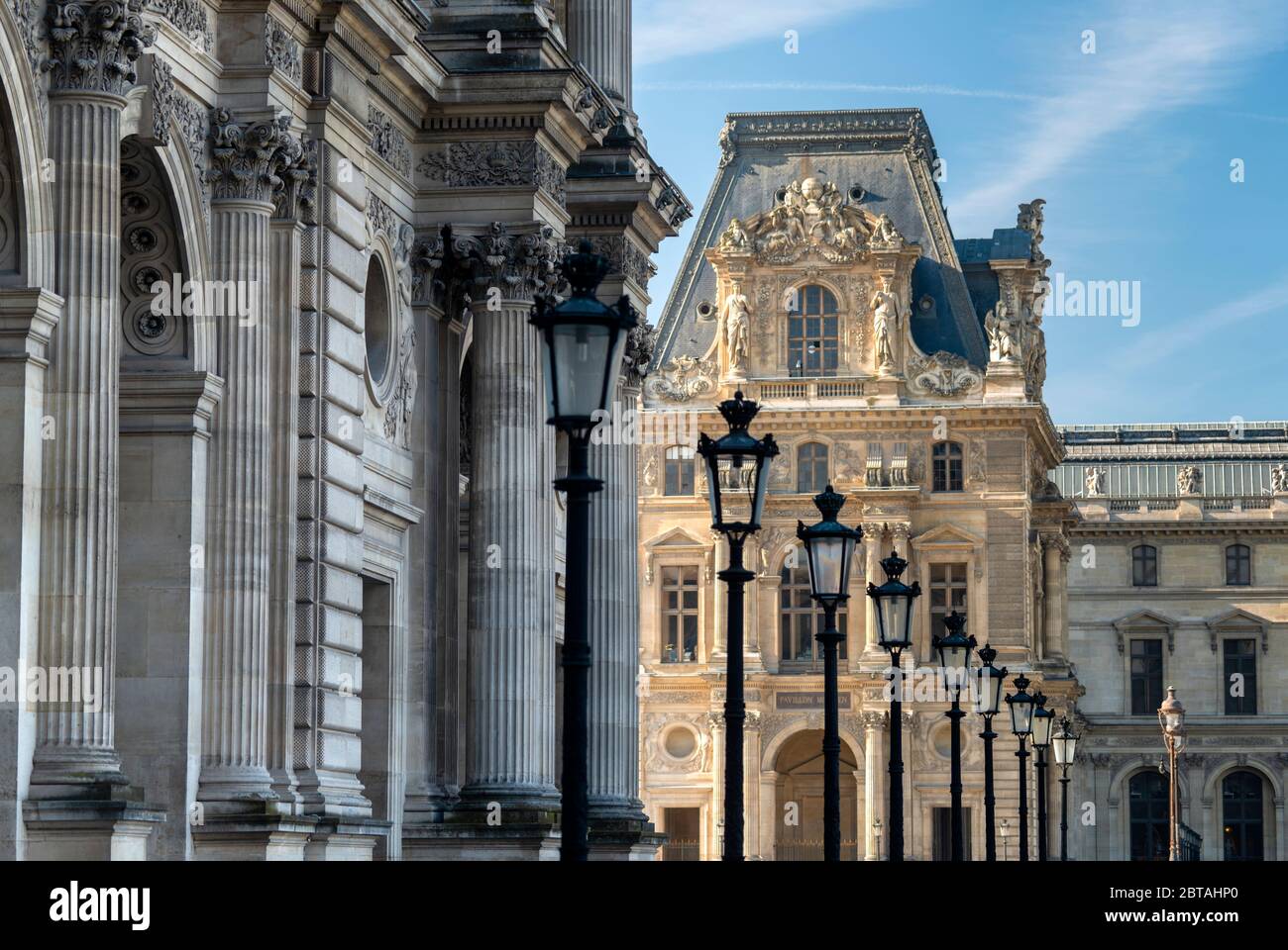 Morning view of the Louvre Museum with street lights and blue sky in ...