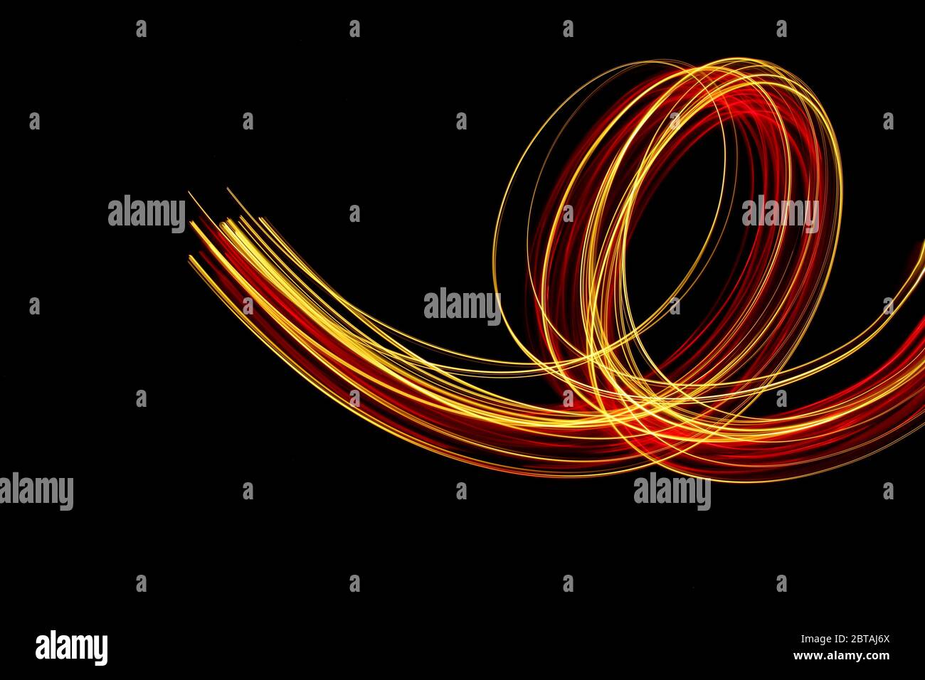 Long exposure photograph of neon colour in an abstract swirl, parallel ...