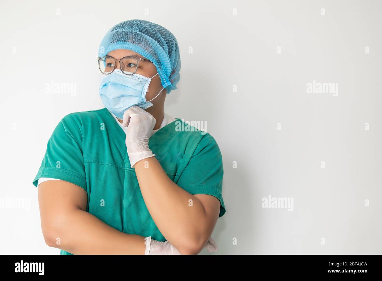young male doctor. Thinking doctor. Face in a medical mask close-up ...