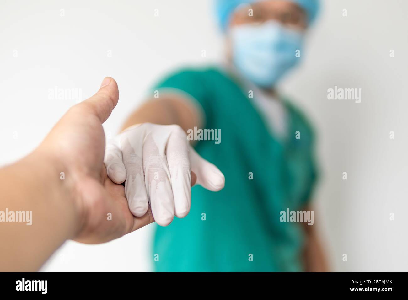 Friendly male medicine doctor hands holding patient hand for ...