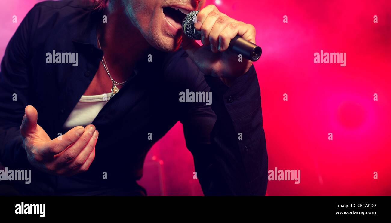 Young Man Singing at rock Concert Stock Photo - Alamy