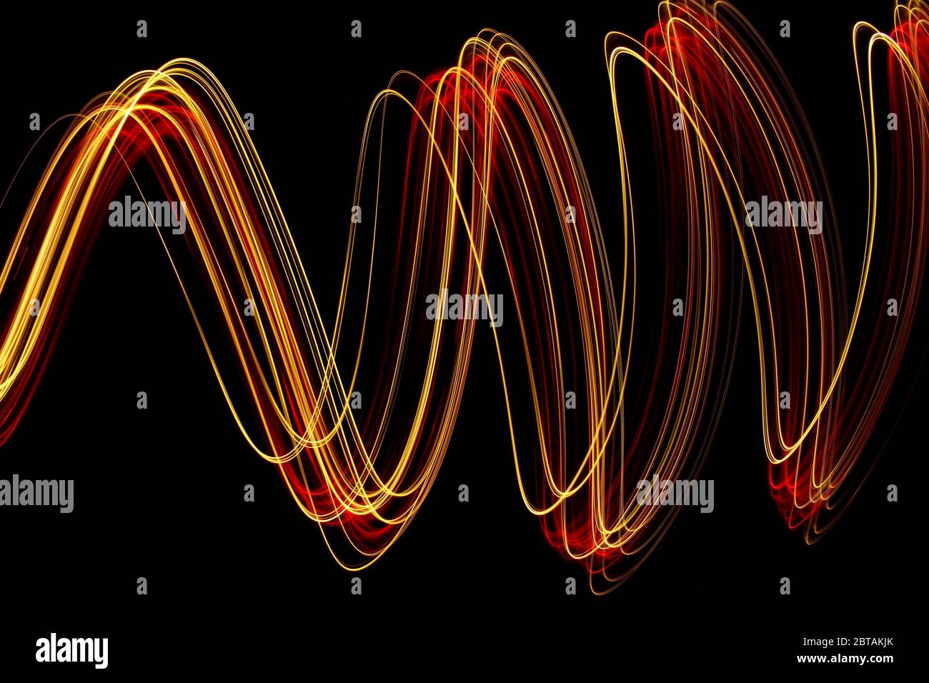 Long exposure photograph of neon colour in an abstract swirl, parallel ...