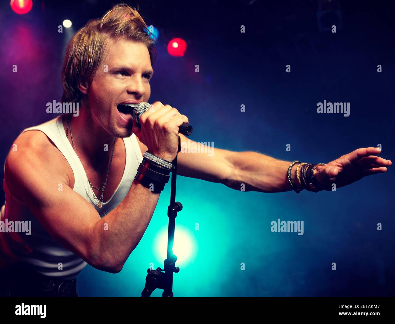 Young Man Singing at rock Concert Stock Photo - Alamy