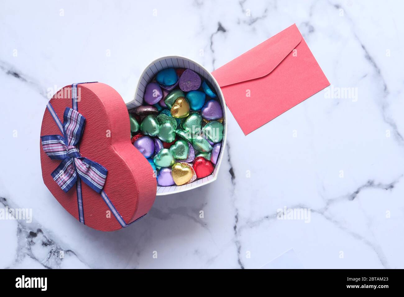 heart shape gift box, candy and letter on tiles background Stock Photo ...