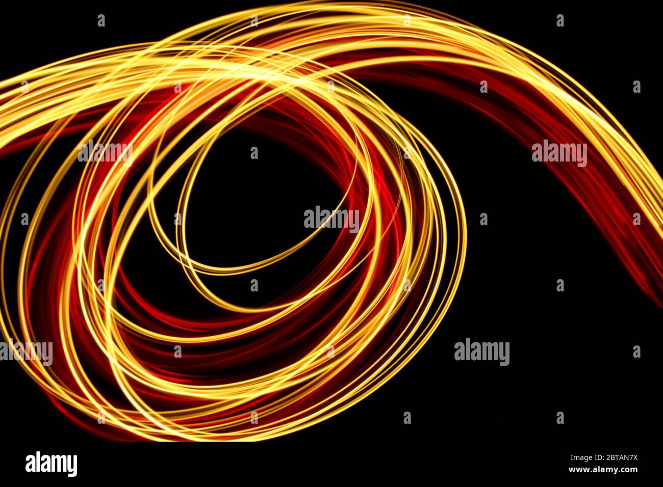 Long exposure photograph of neon colour in an abstract swirl, parallel ...
