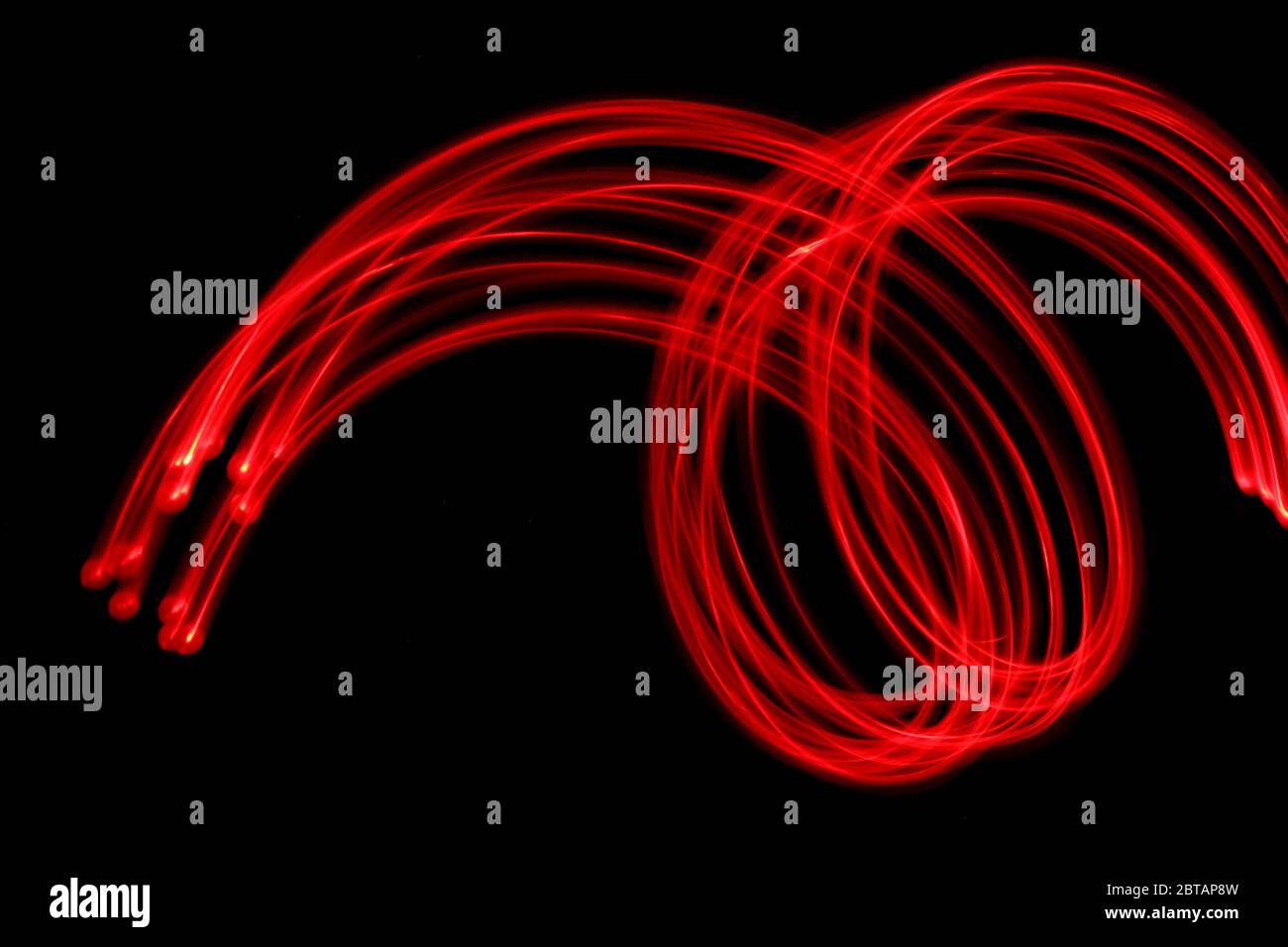 Long exposure photograph of neon colour in an abstract swirl, parallel ...