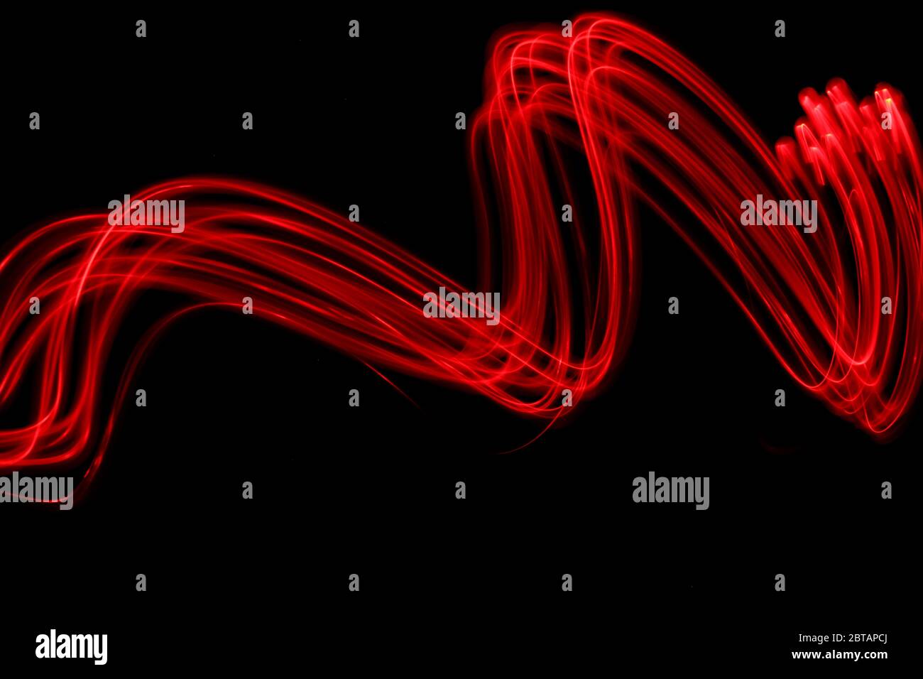 Long exposure photograph of neon colour in an abstract swirl, parallel ...