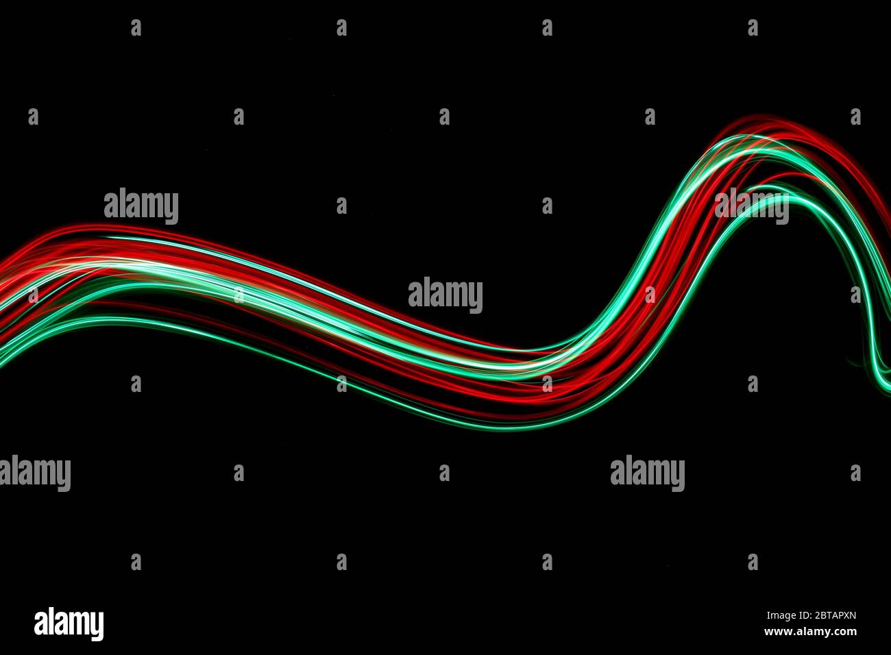 Long exposure photograph of neon colour in an abstract swirl, parallel ...