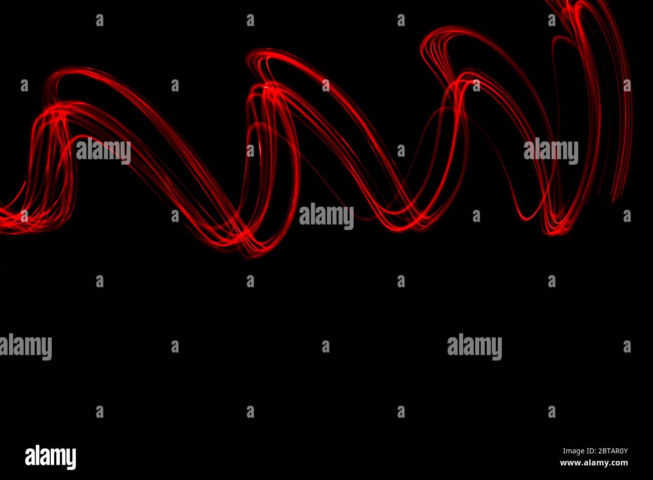 Long exposure photograph of neon colour in an abstract swirl, parallel ...