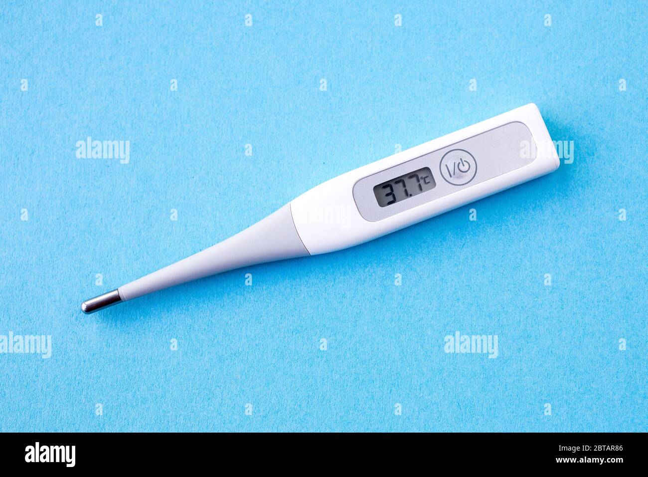 detail of digital thermometer with 37,7 °C of fever, flu, covid19 ...