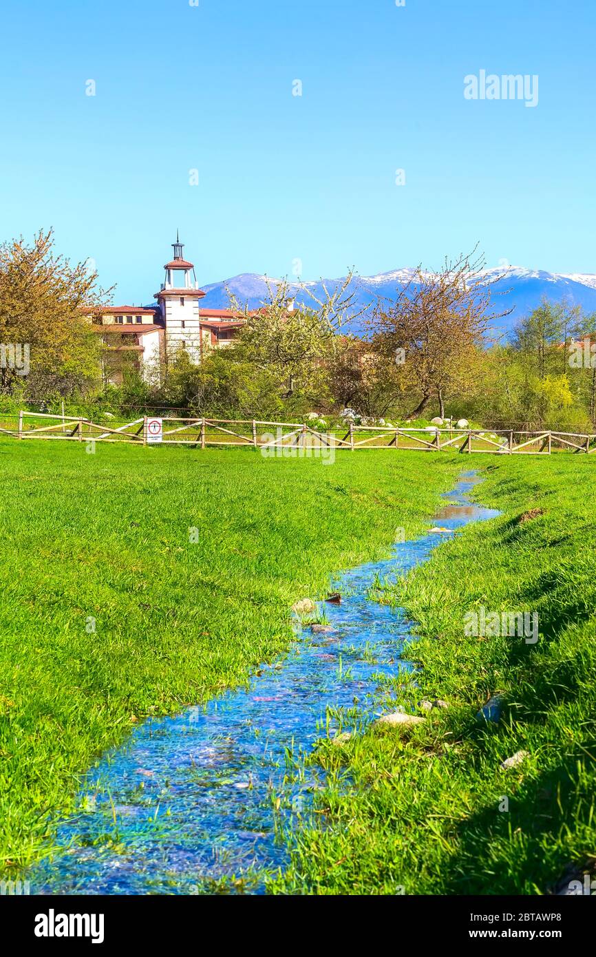 Spring in Bansko, Bulgaria with melting snow water and houses. Snowy ...