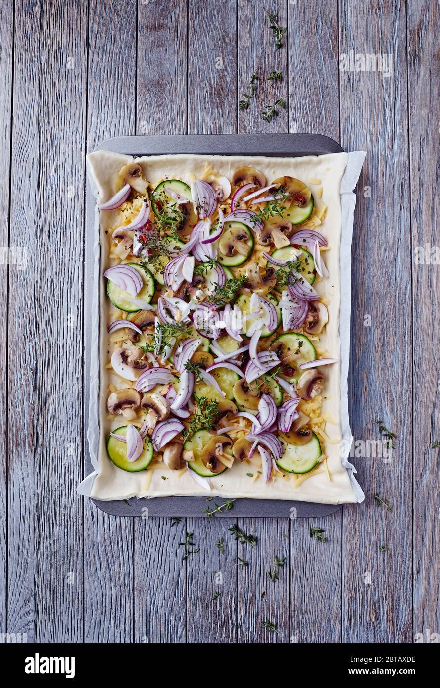 Pizza prepared to bake. Rustic wooden background. Top view Stock Photo ...