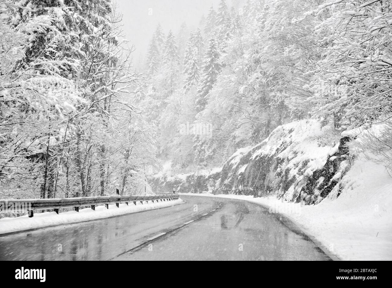 Snowfall and ice on road - Austria Stock Photo - Alamy