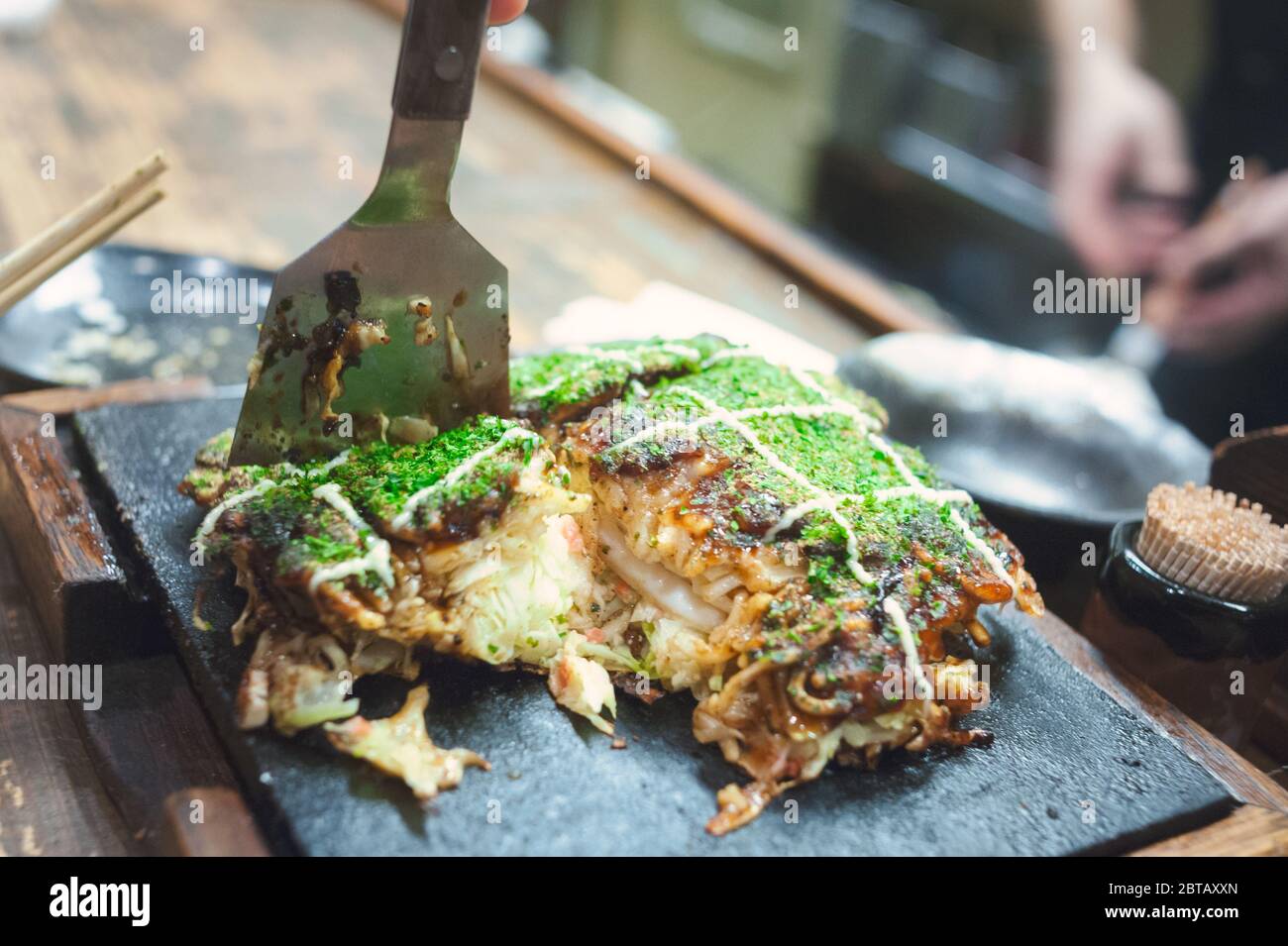 In Osaka, Japanese soul food from Kansai region, the okonomiyaki is a ...