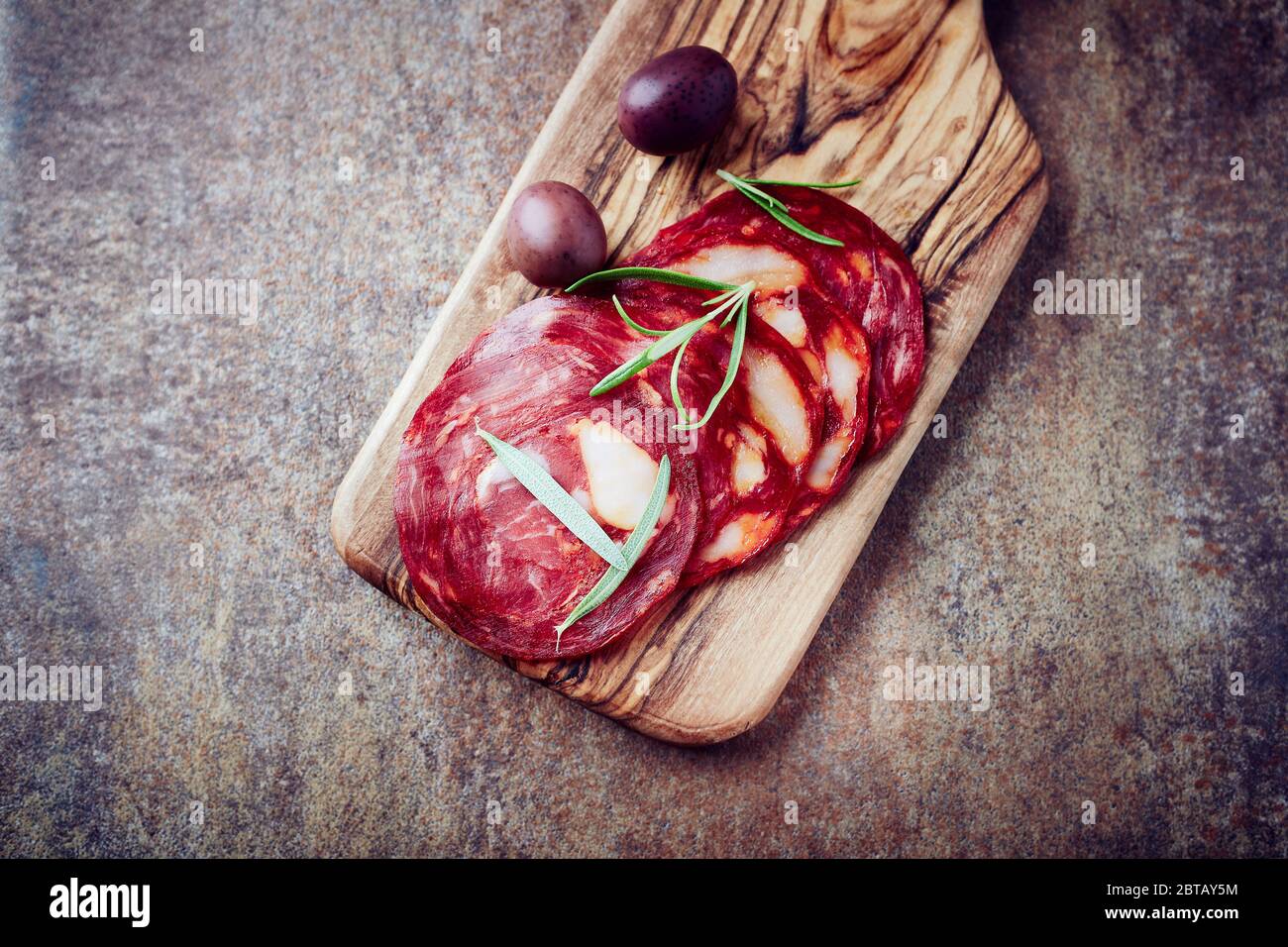 Sliced chorizo with fresh rosemary on rustic background. Top view Stock ...