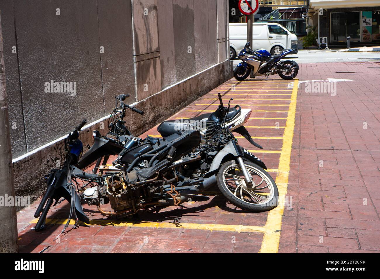 Disassembled by vandals abandoned bike in a parking lot Stock Photo - Alamy
