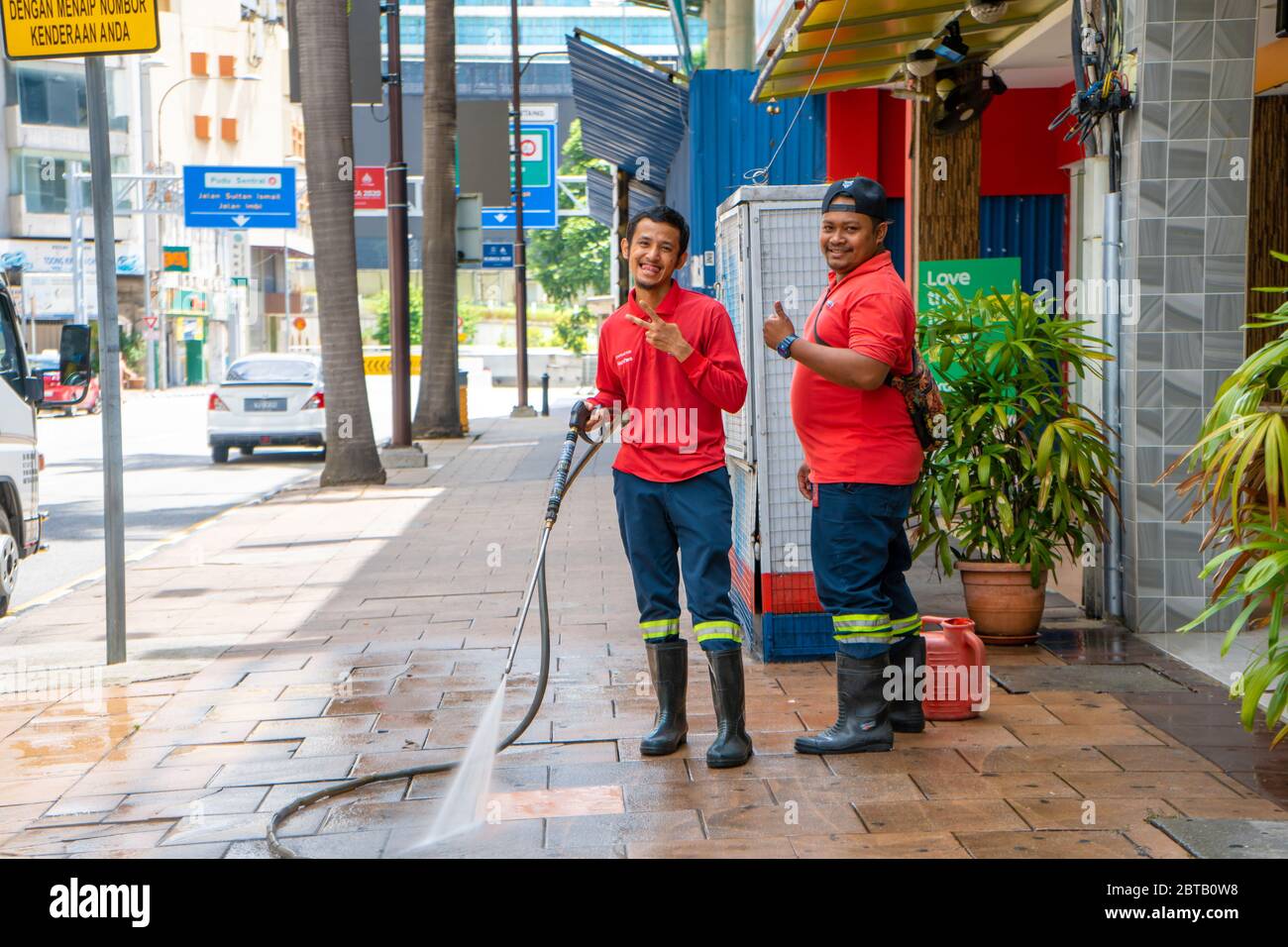Utility workers in Malaysia wash the streets of the city. Malaysia ...